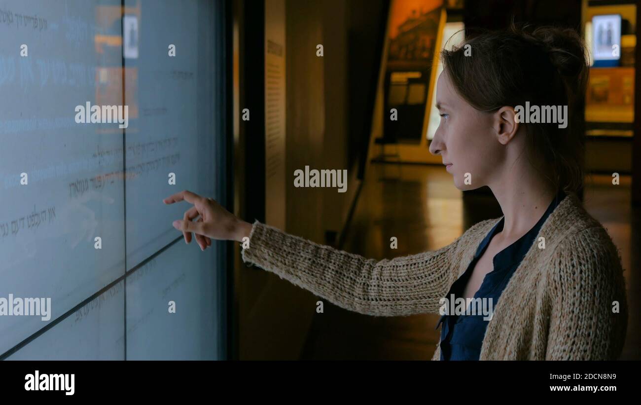 Woman using interactive touchscreen display Stock Photo - Alamy