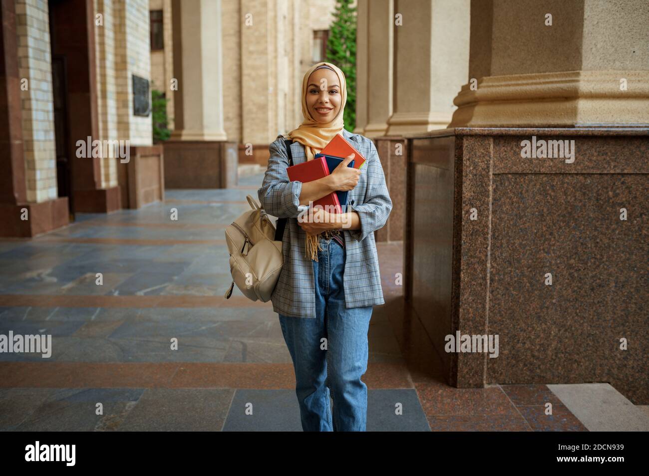 Arab student with books at university entrance Stock Photo - Alamy