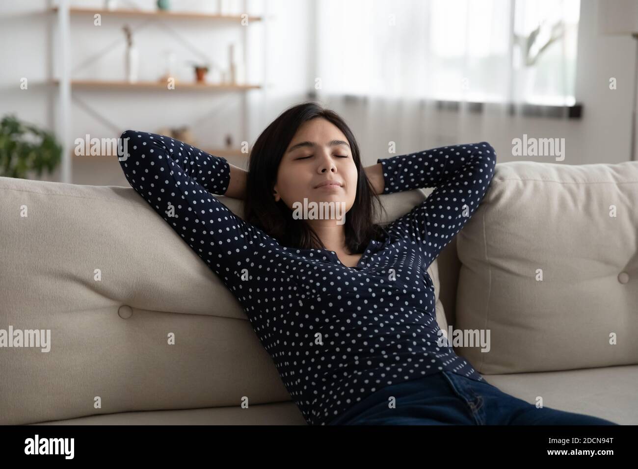 Close up peaceful Asian woman leaning back on cozy couch Stock Photo ...