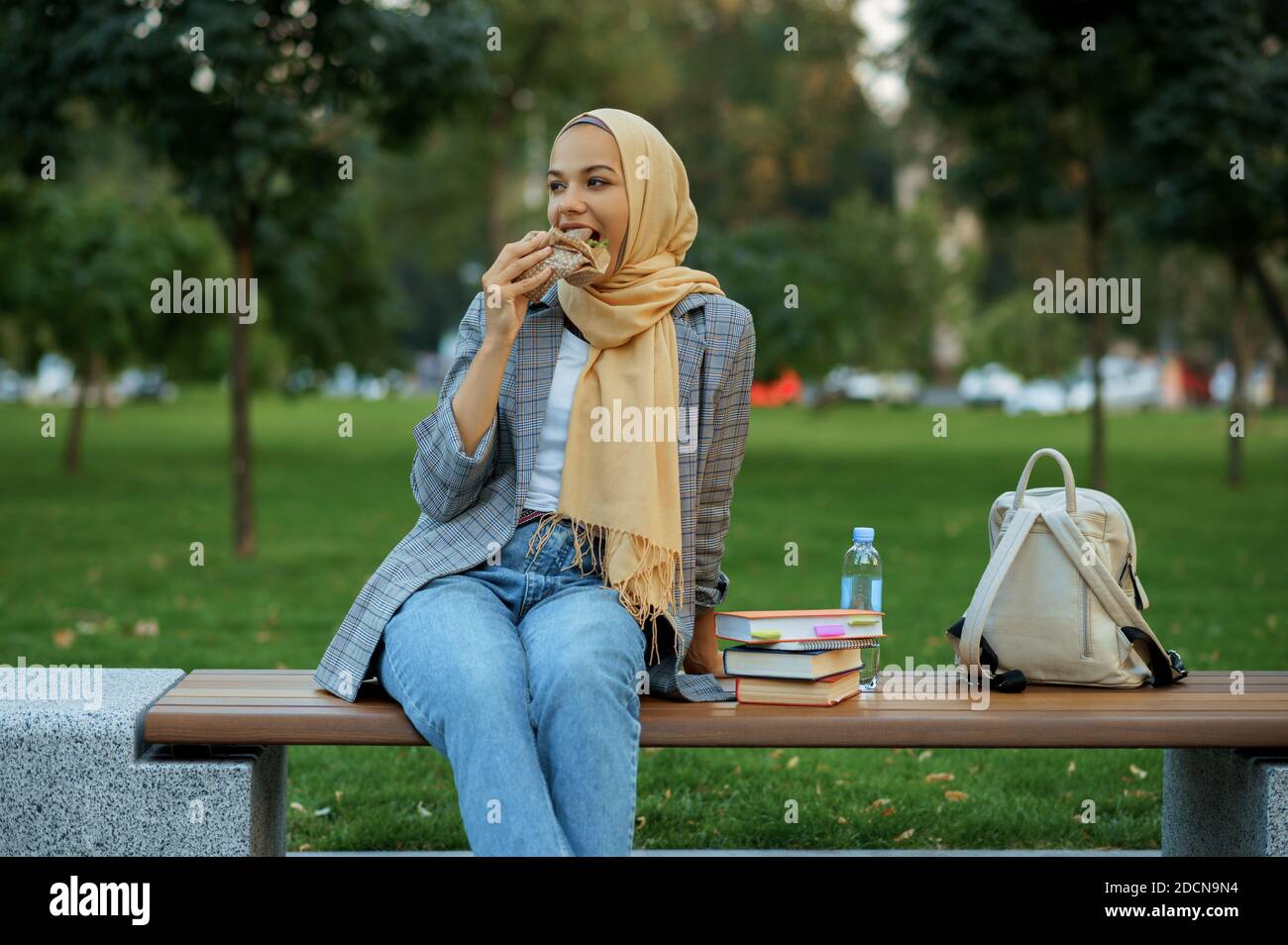 Muslim women sitting on bench hi-res stock photography and images - Alamy