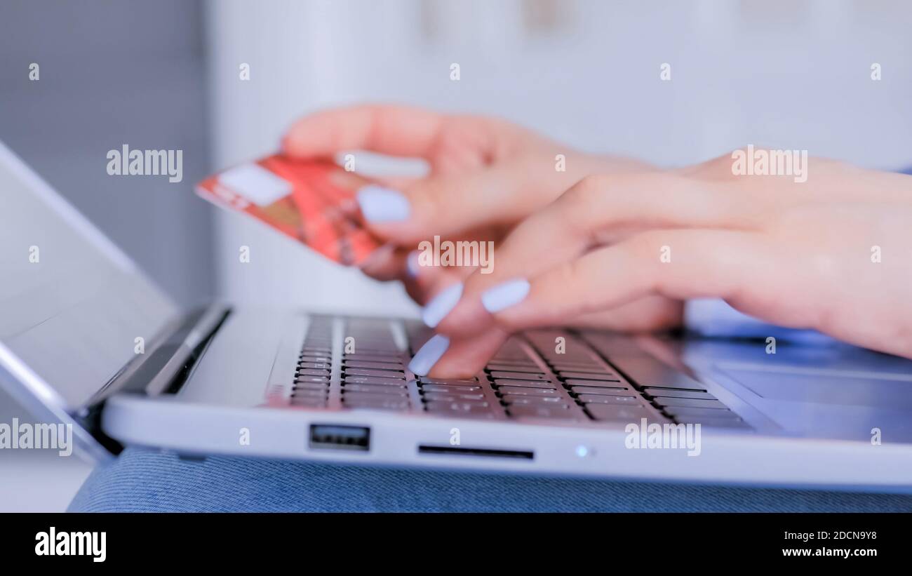 Woman hands using laptop computer keyboard and credit card for online ...
