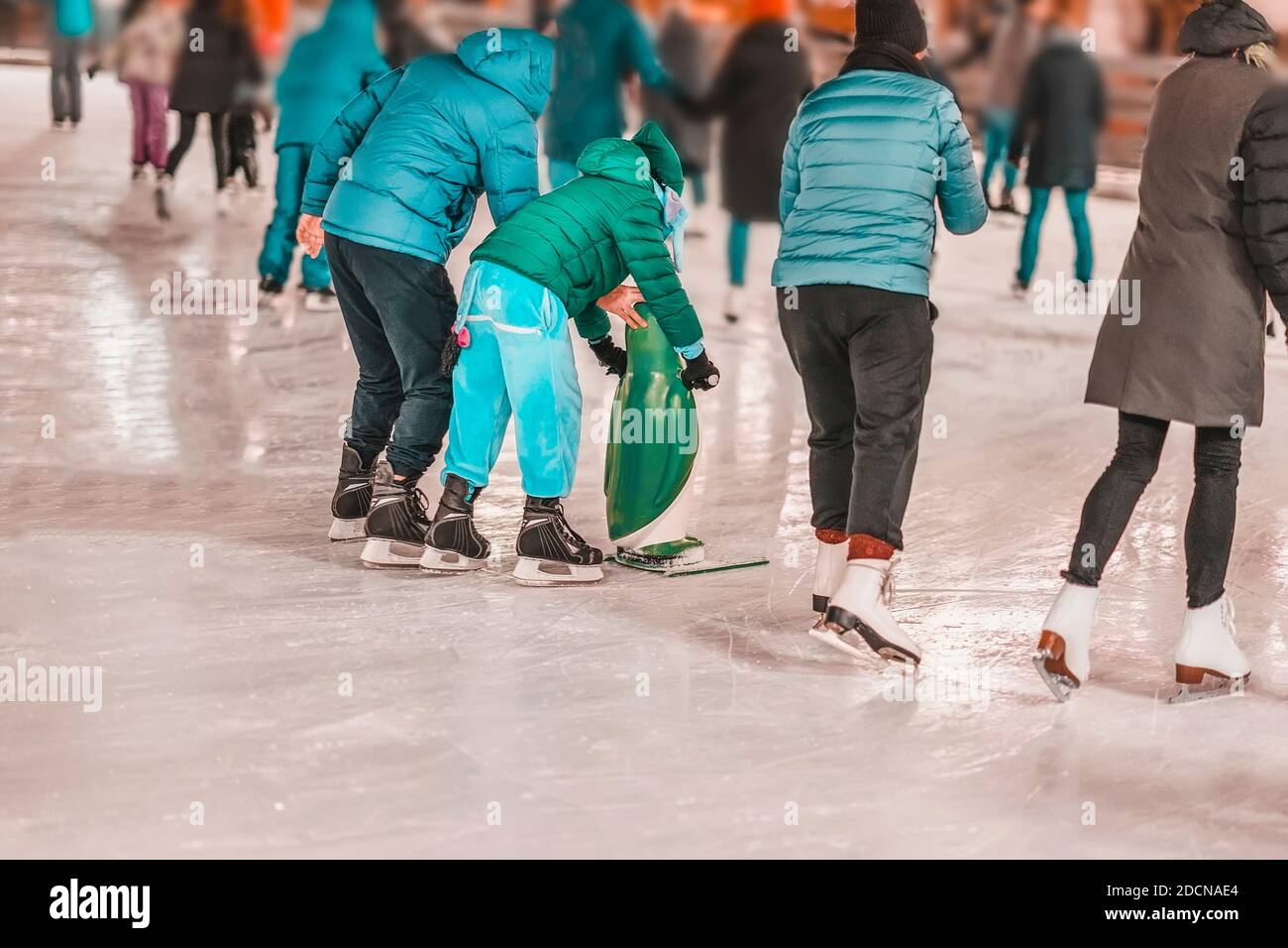 Group of people, happy families skating back to us, vacation with kid ...