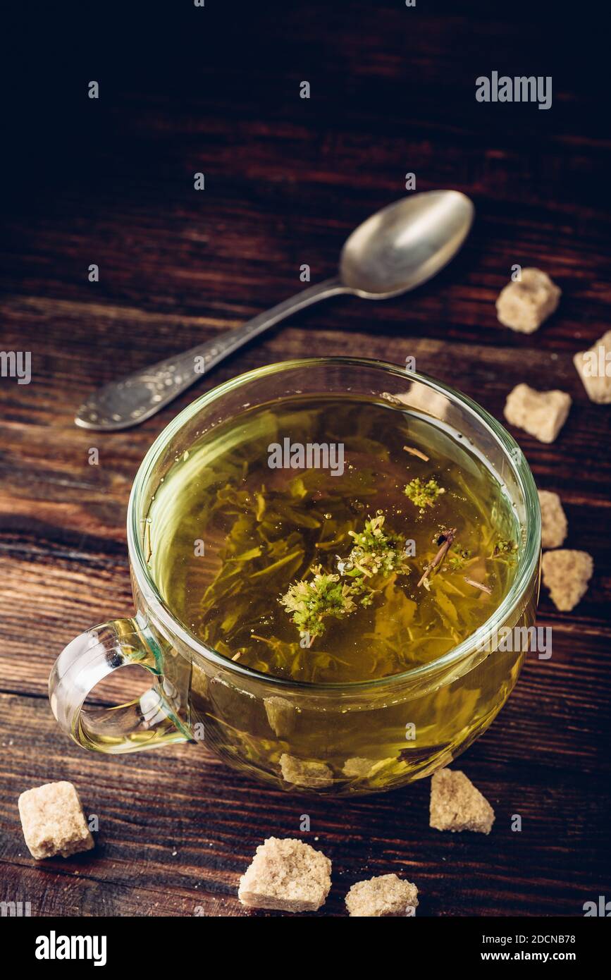 Cup of green tea with brown tea sugar Stock Photo - Alamy
