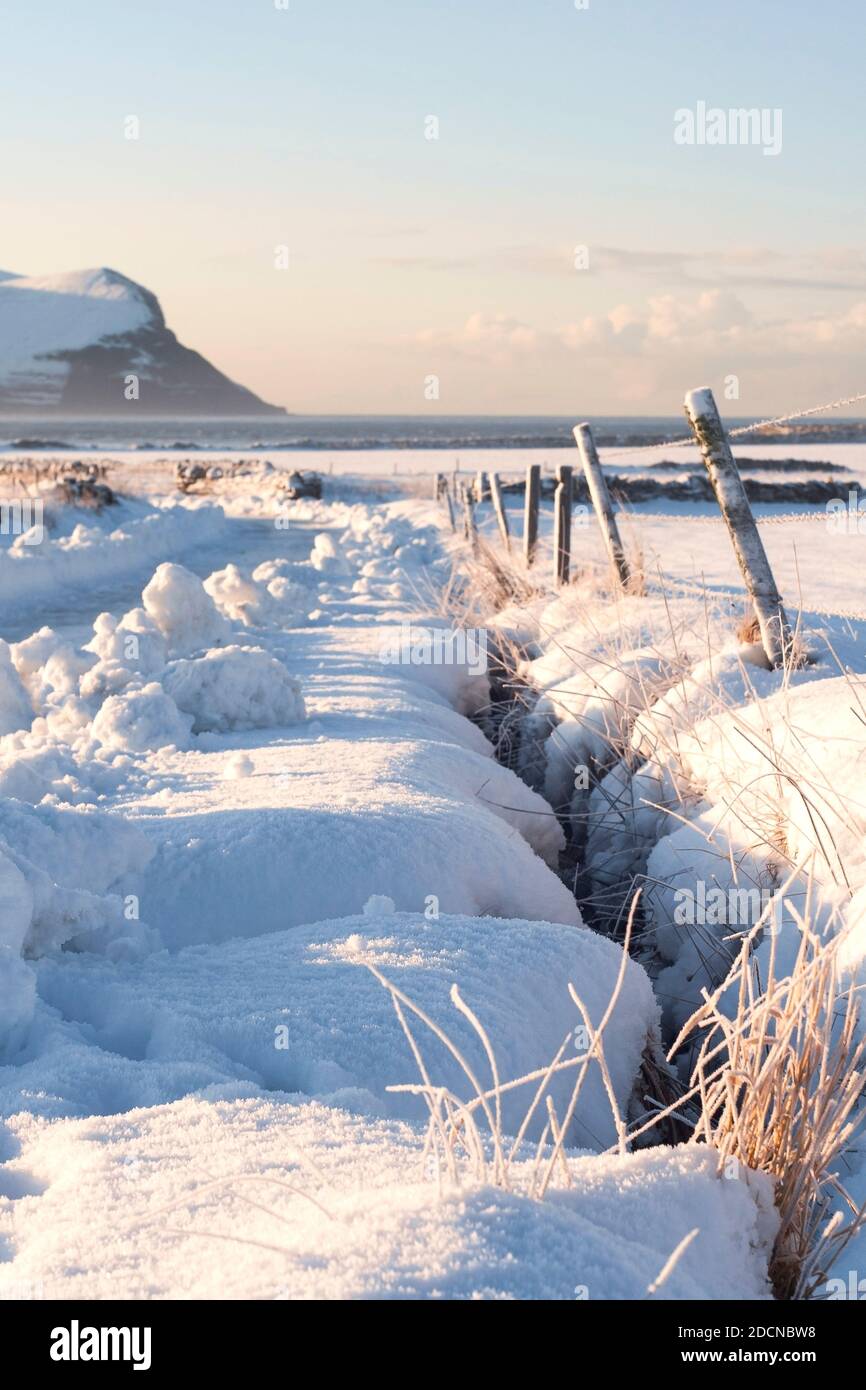 Winter scene with ditch and road on Orkney island Stock Photo - Alamy