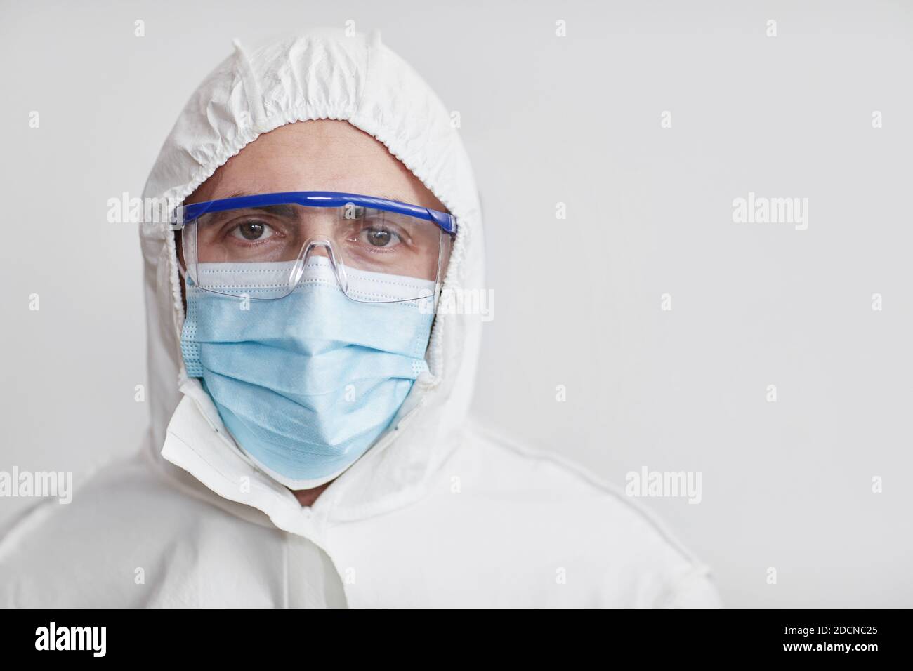 Close up portrait of male medical worker wearing full protective gear ...