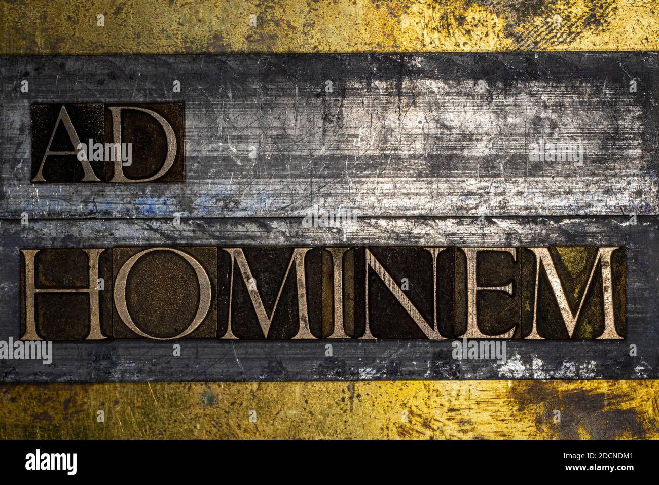 Ad Hominem text message on lead bar on textured grunge copper and ...