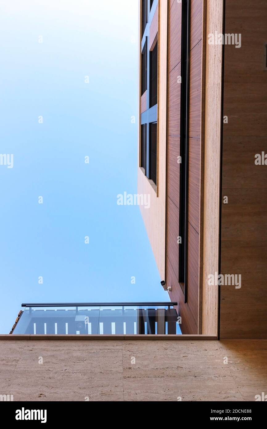 Bottom view. Facade of a contemporary apartment building with a blue ...