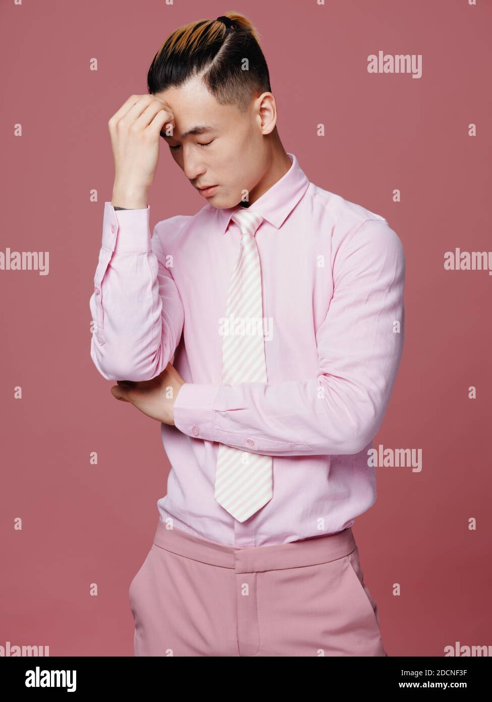 Pensive man holds his hand near his head emotions self confidence pink ...