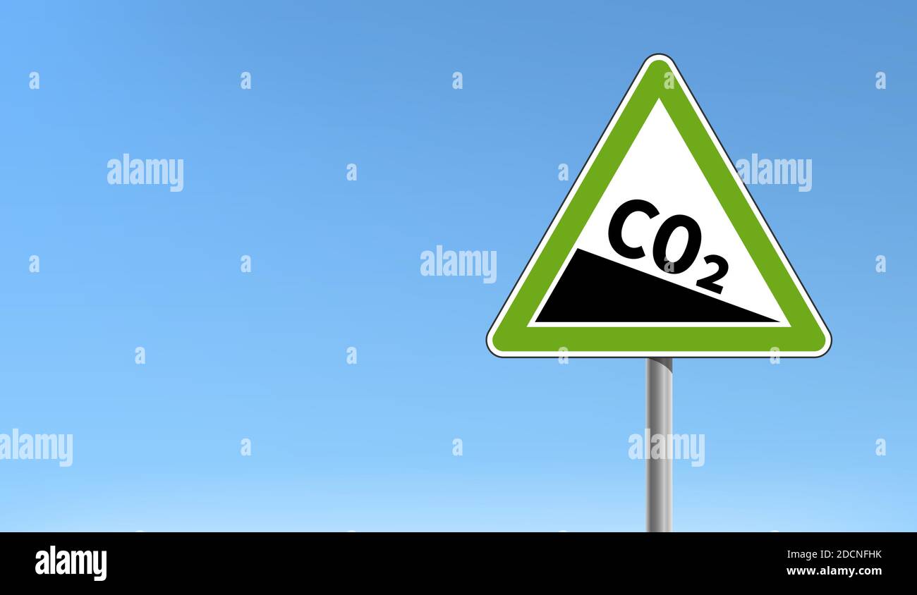 CO2 emission reduction sign green triangular shape blue sky background ...