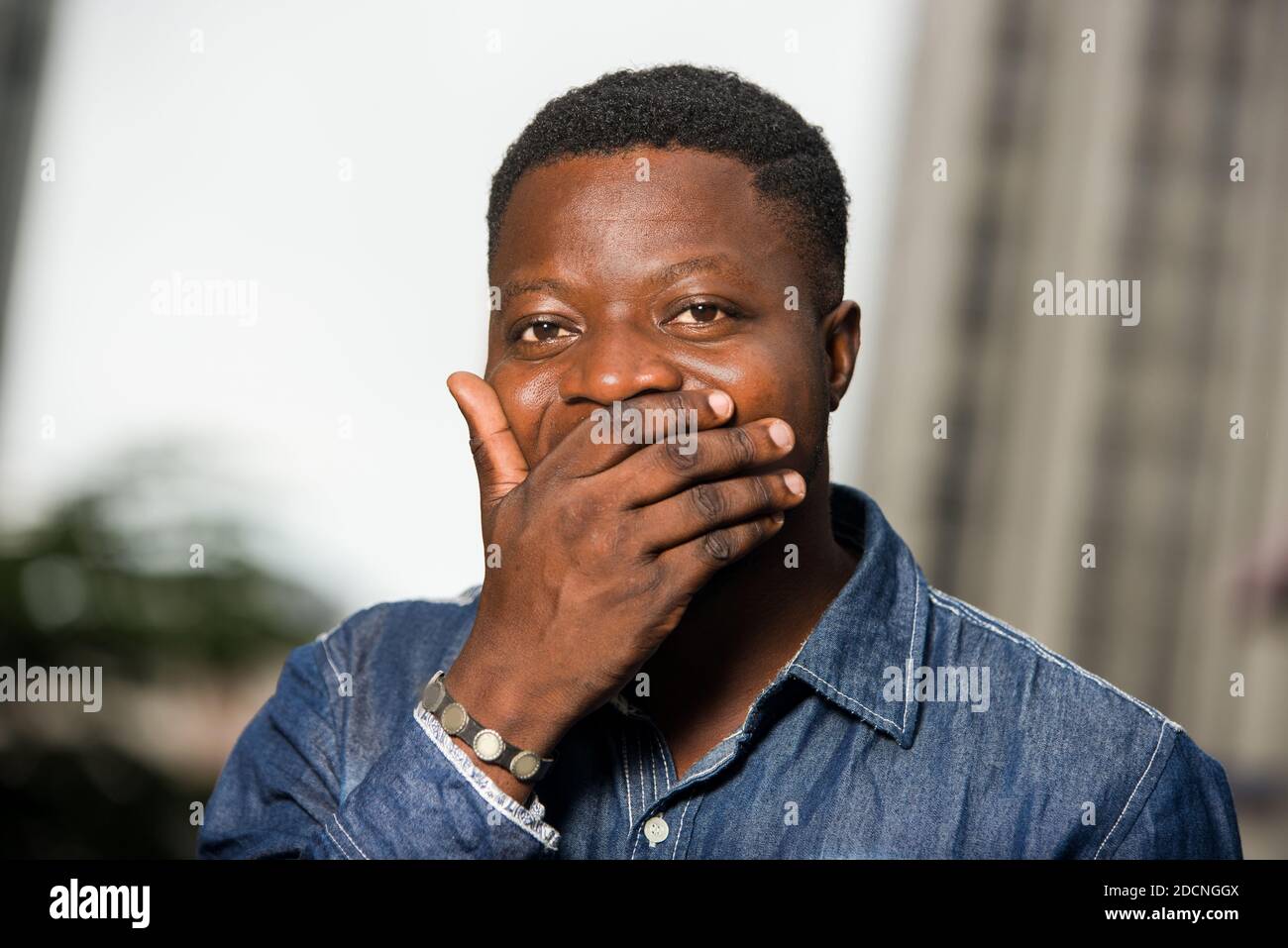 Laughing man covering mouth hand hi-res stock photography and images ...