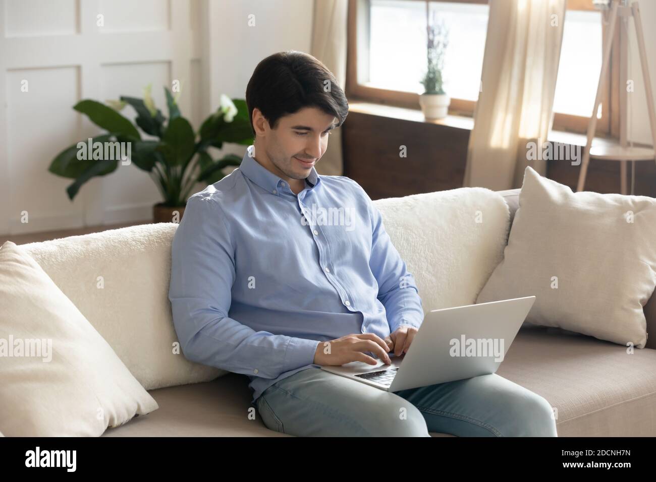 Calm young man using laptop hi-res stock photography and images - Alamy