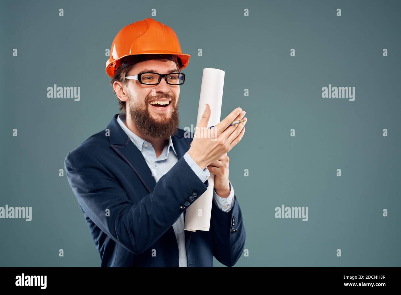 Male engineer wearing a suit in orange paint safety work drawings Stock ...