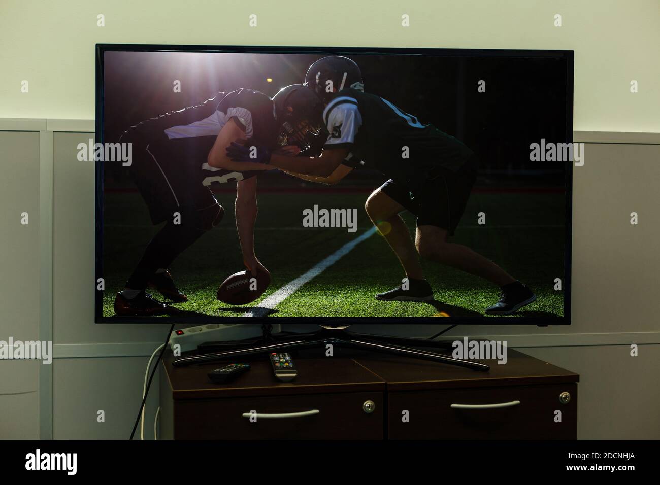 football match football on the big screen tv Stock Photo - Alamy