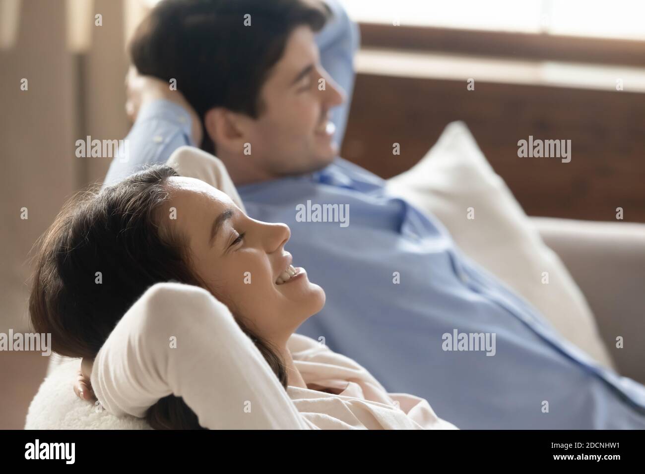 Content young couple resting at home leaning back on sofa Stock Photo ...