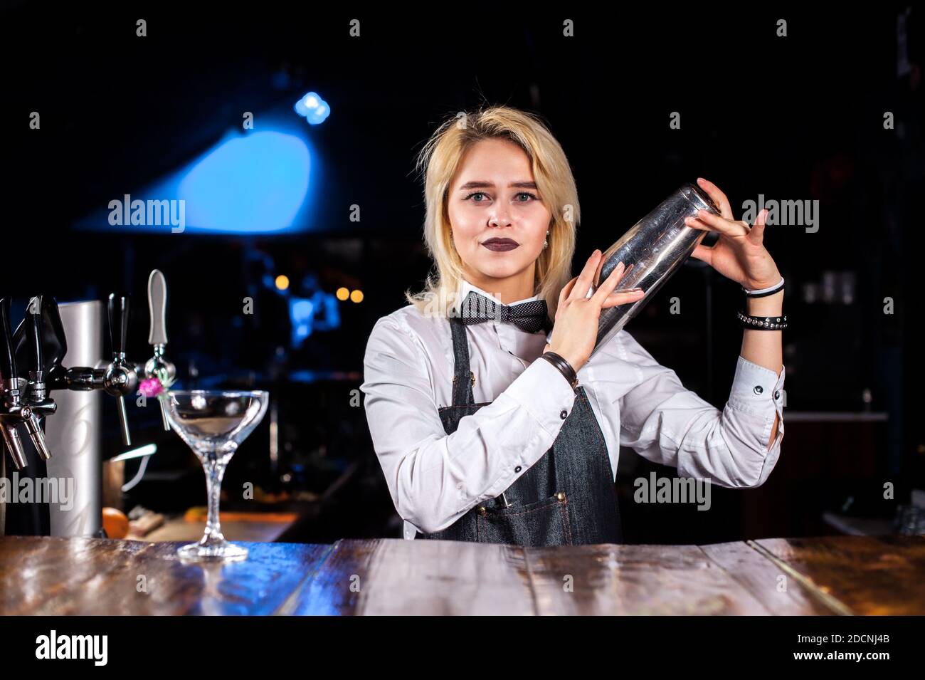 Girl bartender creates a cocktail on the saloon Stock Photo - Alamy