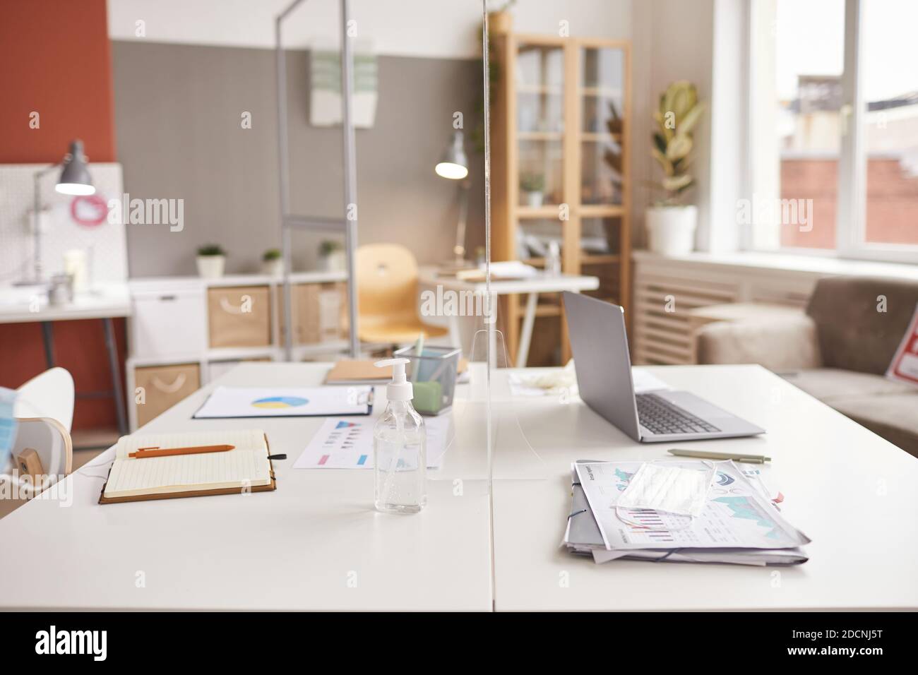 Background image of two office desks separated by glass pane at post ...
