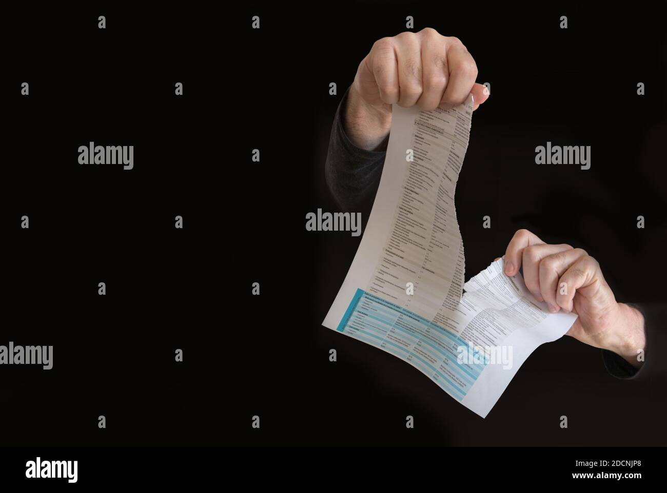 The heads of a man tearing up a document, low key, isolated, copy space ...