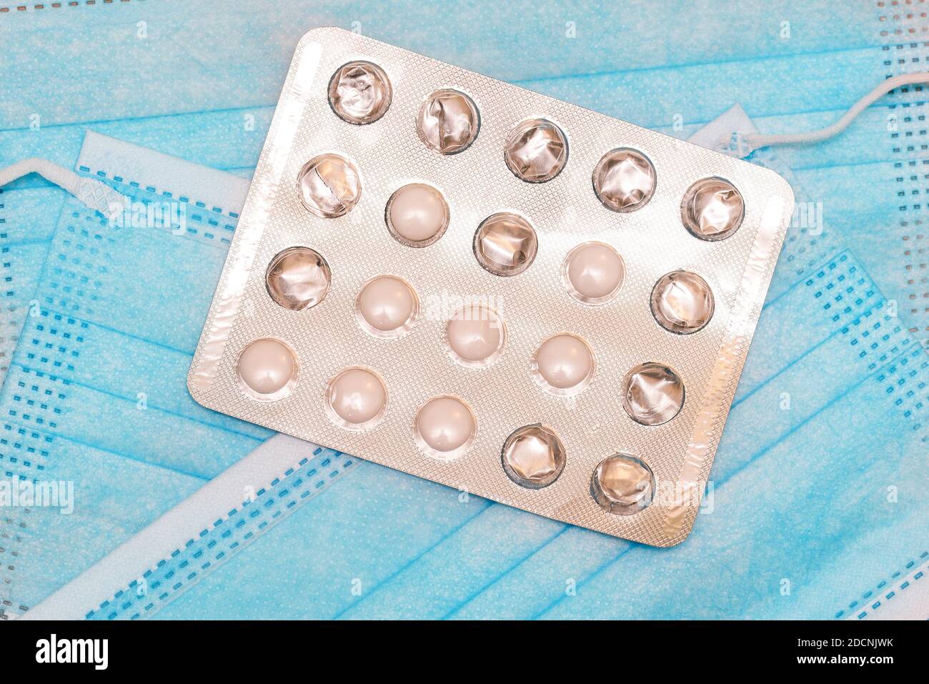 Silver packaging with pills and disposable medical masks. Medicine and ...