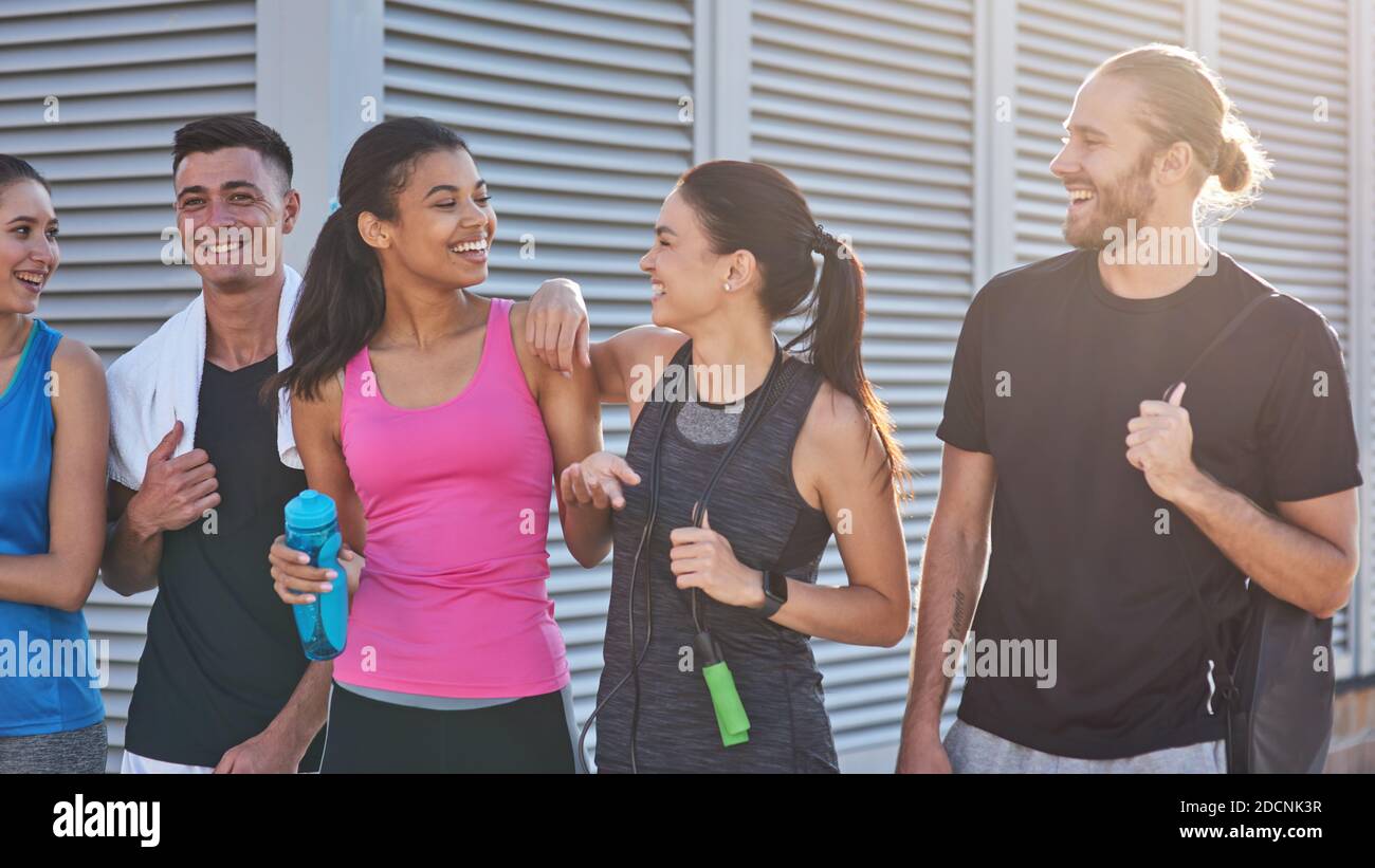 Young sportive people happily talking while going to gym Stock Photo ...