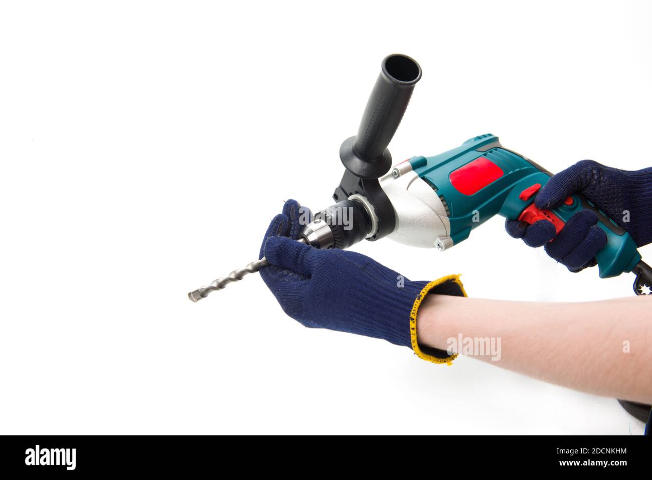 Man in protective gloves change drill in electric perforator at cut out ...