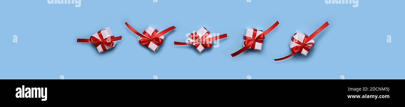 Light blue banner with five small miniature boxes, packed in white ...