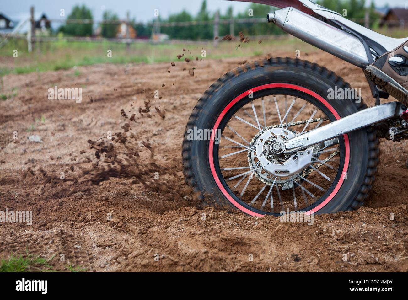 Motocross riding in sandy race track, rear rotating wheel of dirtbike ...