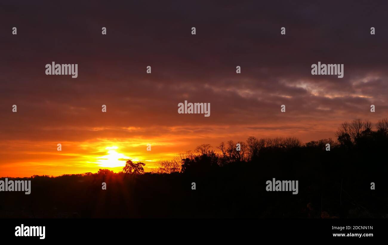 Amazing sunrise in rural scene. Dramatic sky with sunbeam and stratus ...