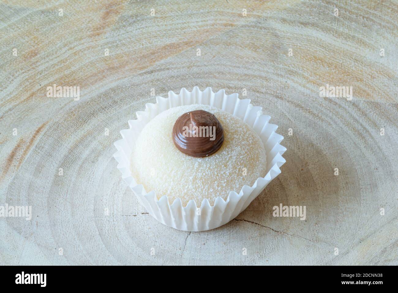 Closeup of a white brigadeiro with chocolate cream (brigadier) on a ...