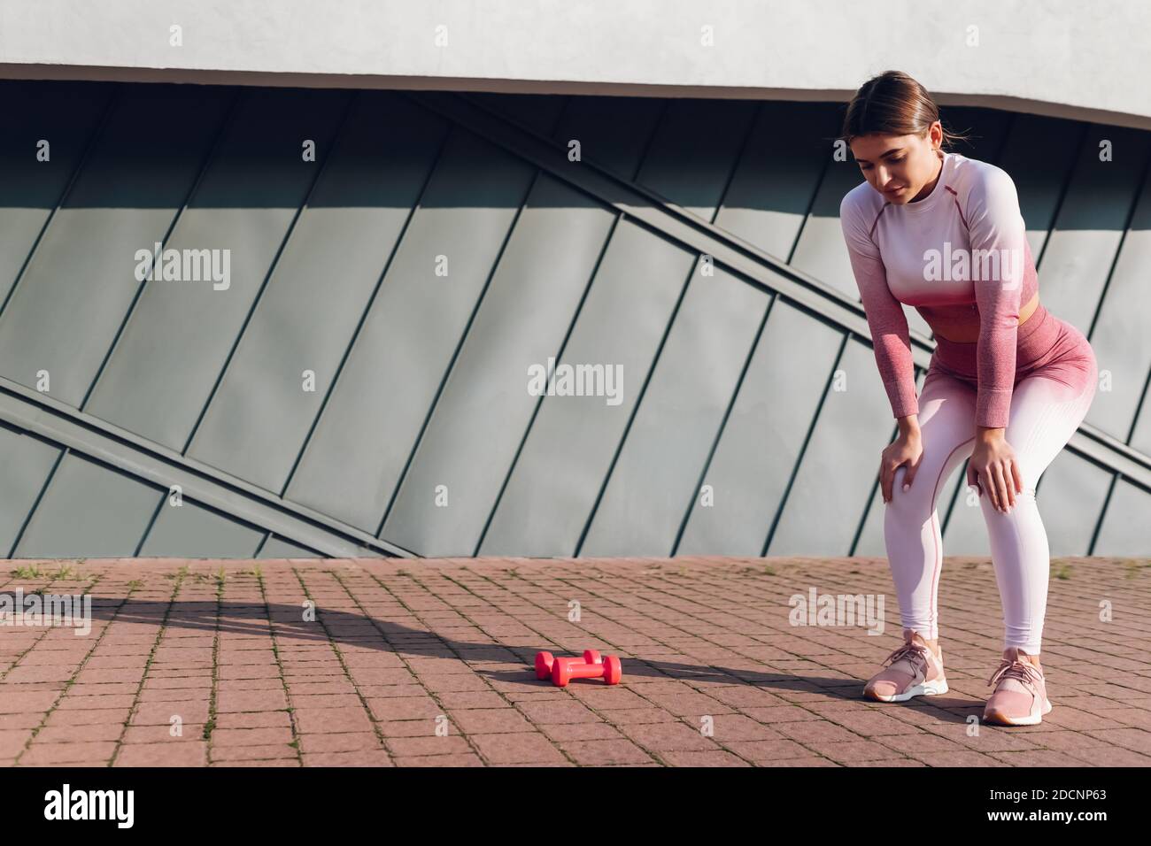 Tired female athlete takes break between exercises Stock Photo - Alamy