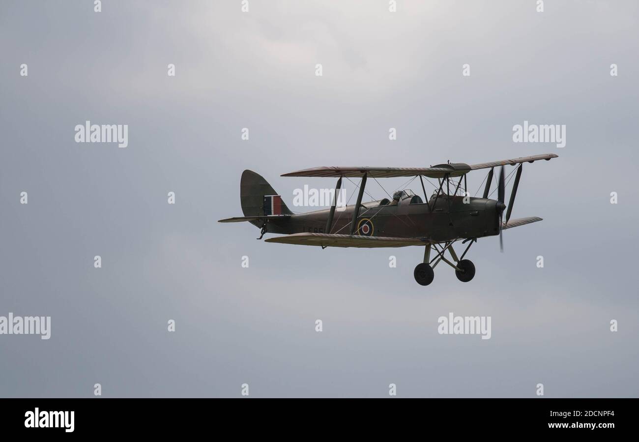 A single engine Gypsy Moth biplane aircraft in flight over White ...