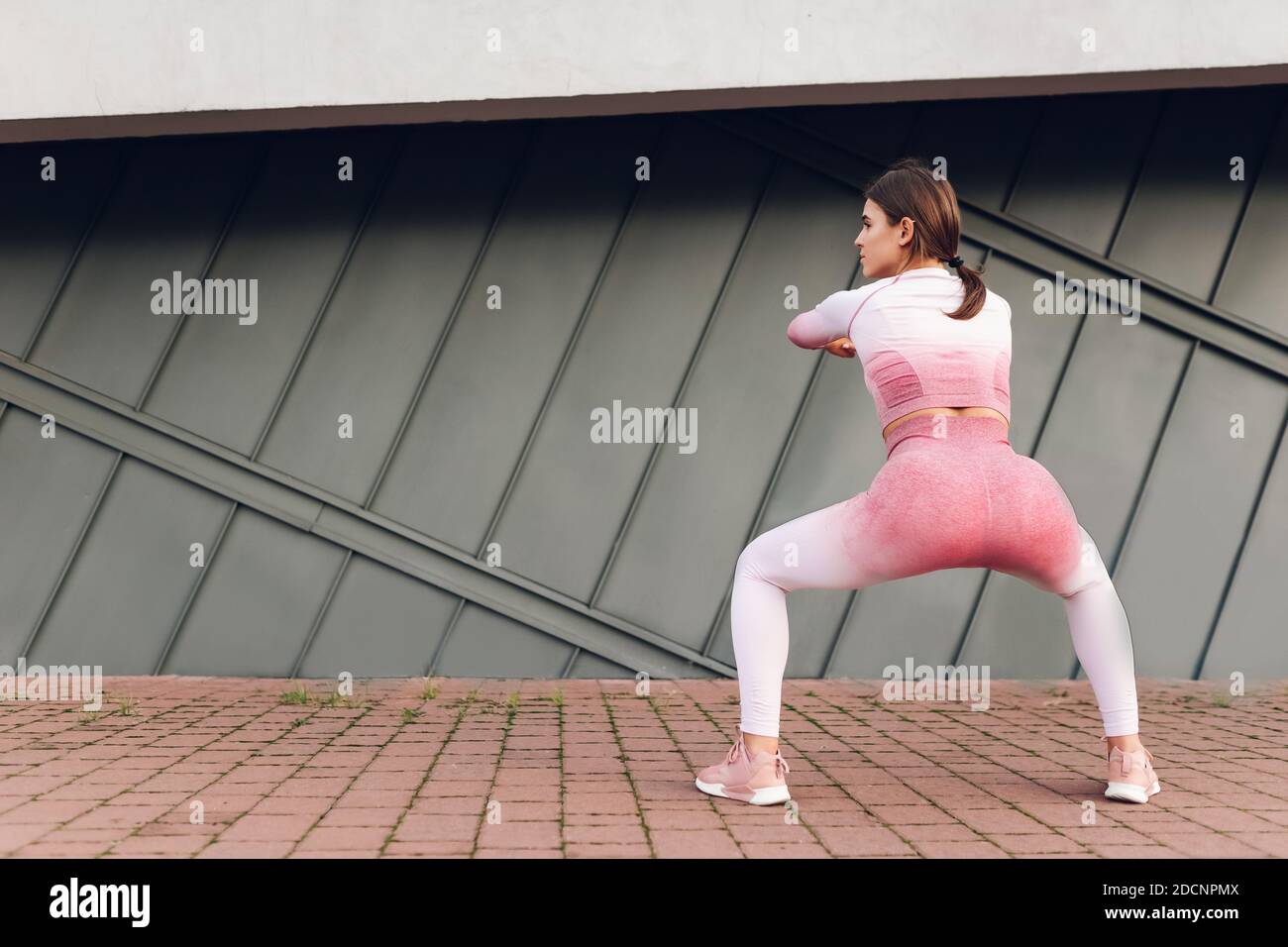 Sports woman doing squats. Female doing exercises on the buttocks Stock ...
