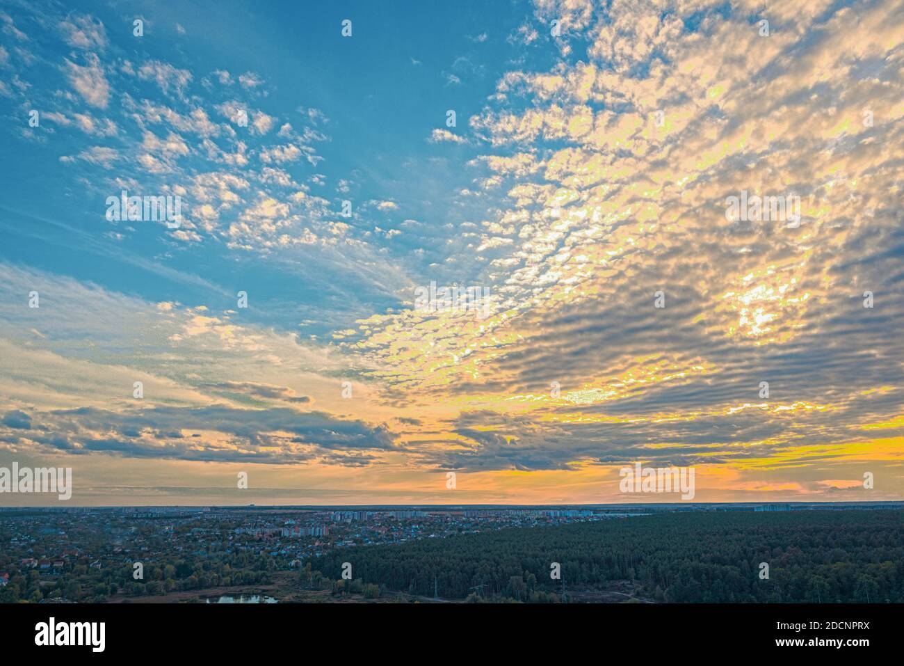 beautiful yellow-blue sky with clouds and overcast at sunset over a ...