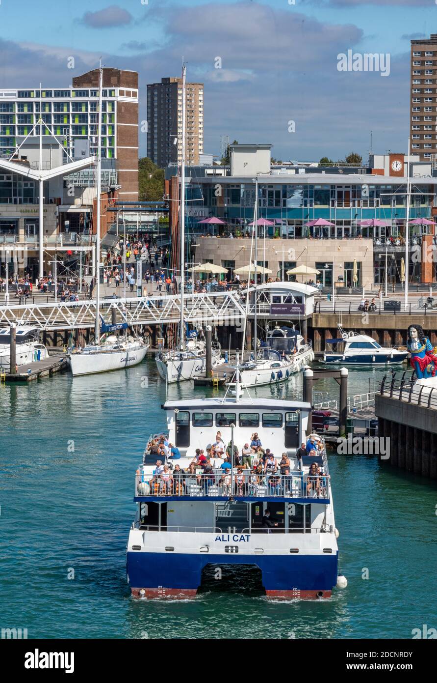a small tourist boat showing visitors on a sightseeing trip aroun the ...