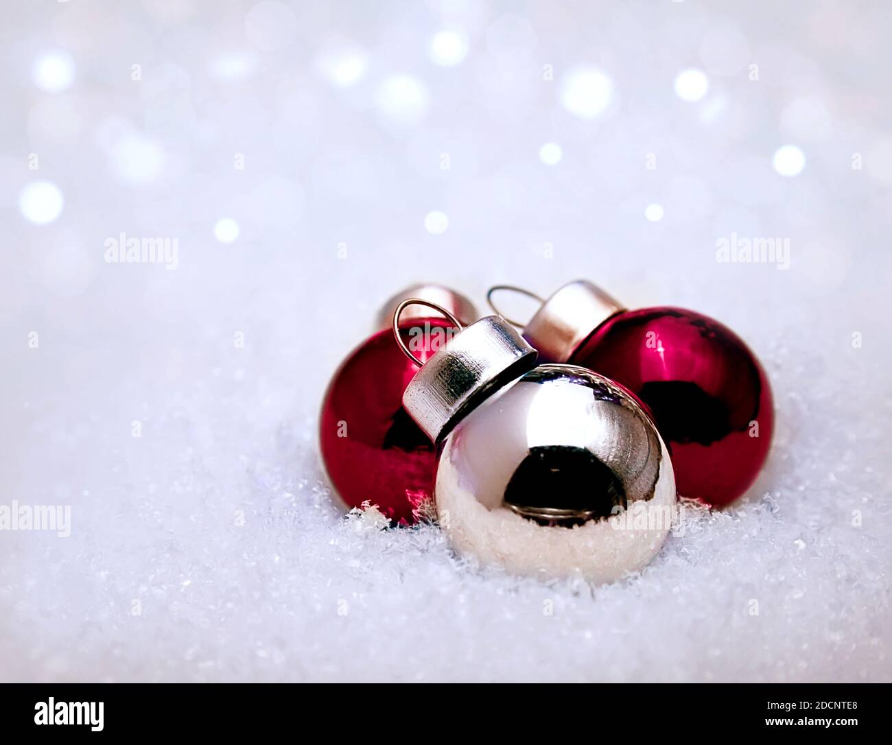Three Christmas balls of different colors in the snow. Christmas ...