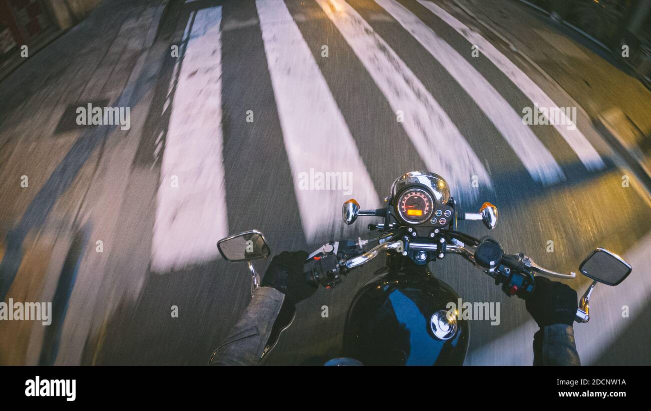Driving a vintage motorbike on a urban road driver point of view Stock ...
