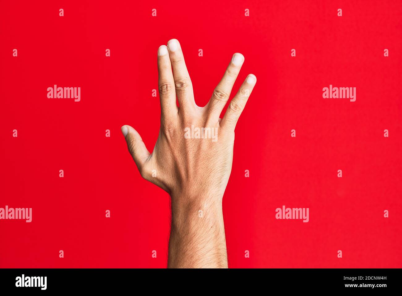 Arm of caucasian white young man over red isolated background greeting ...