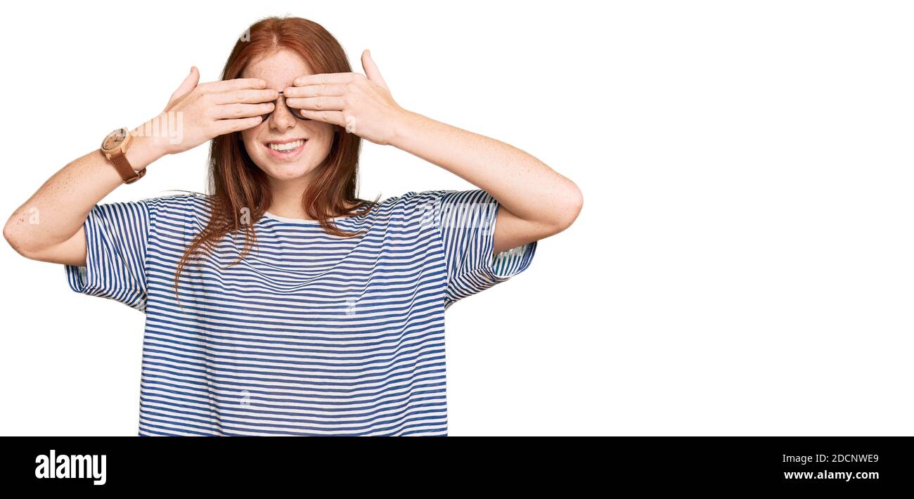 Young read head woman wearing casual clothes and glasses covering eyes ...