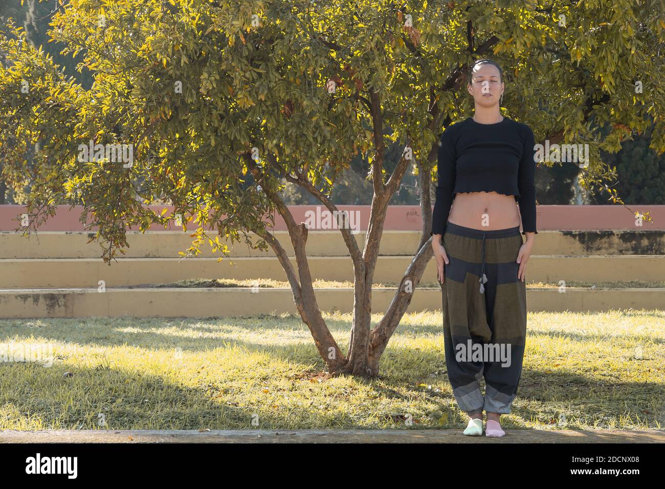 A full-length portrait of a sporty Caucasian woman in a standing stance ...