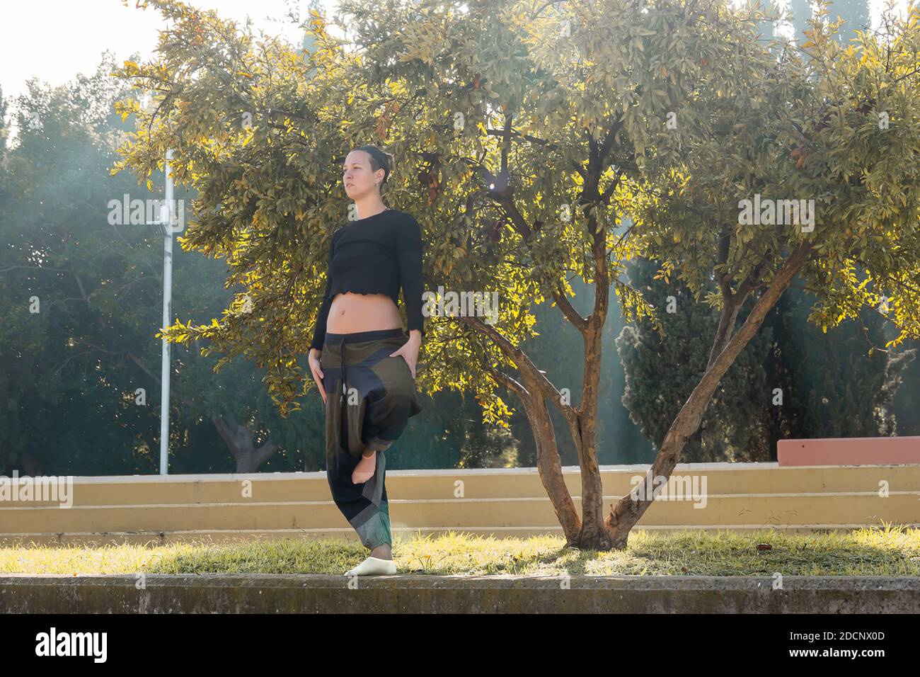 A full-length portrait of a sporty Caucasian woman in a standing stance ...