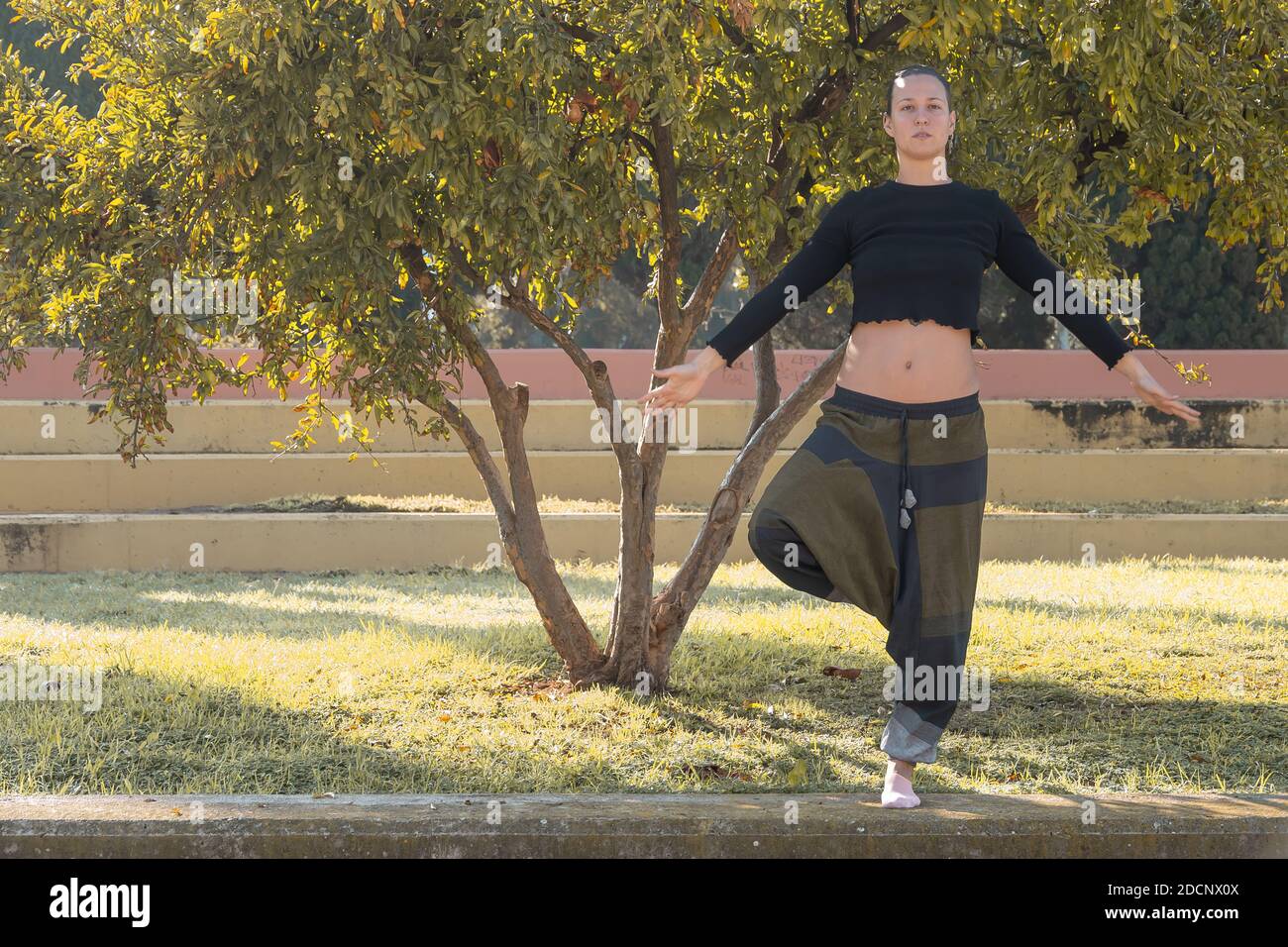A full-length portrait of a sporty Caucasian woman in a standing stance ...