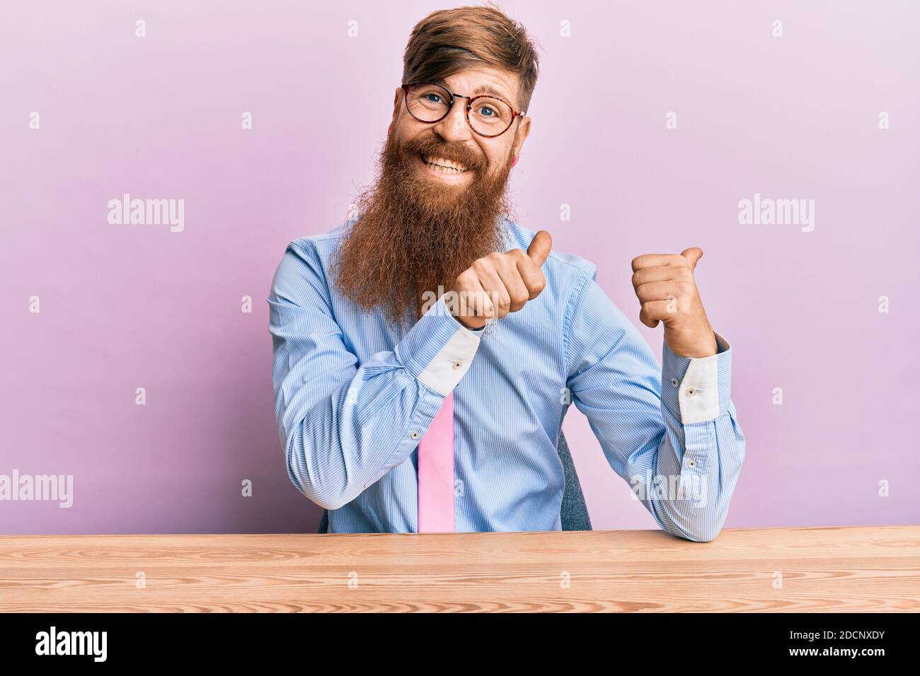 Young irish redhead man wearing business shirt and tie sitting on the ...