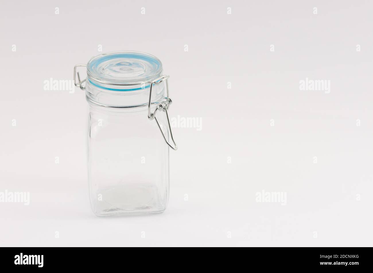 A closeup shot of an empty glass jar isolated on a white background ...