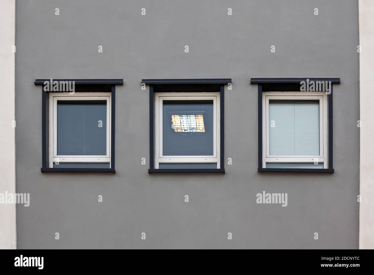 Building facade with square windows and sky Stock Photo - Alamy