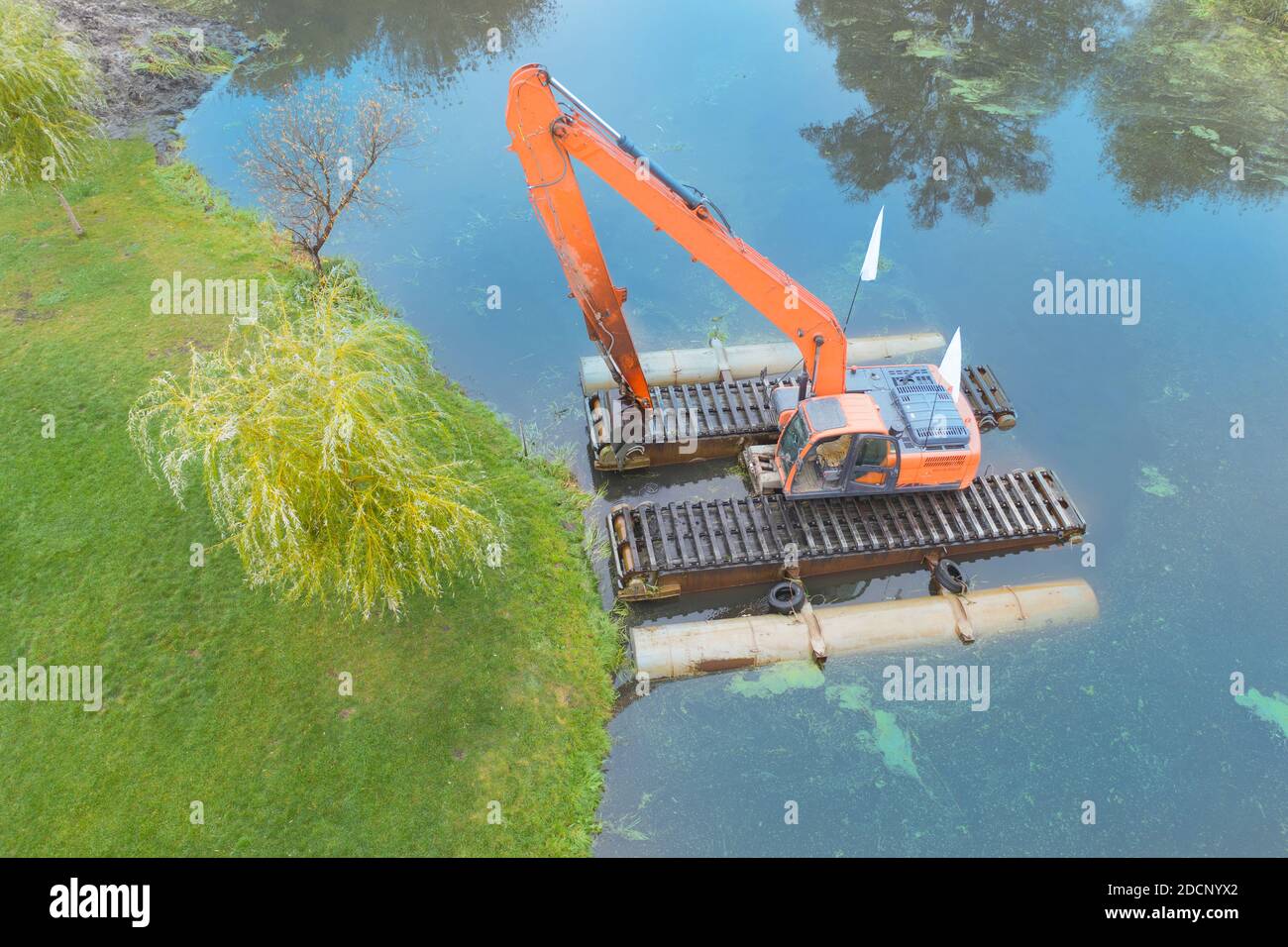 Floating excavator for cleaning ponds, aerial view. Provision of water ...