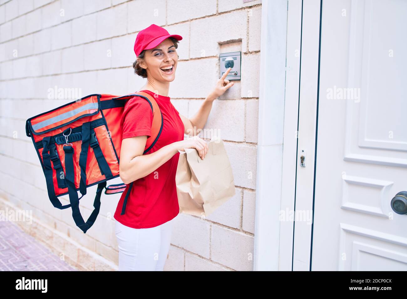 Delivery business worker woman wearing uniform smiling happy knocking ...