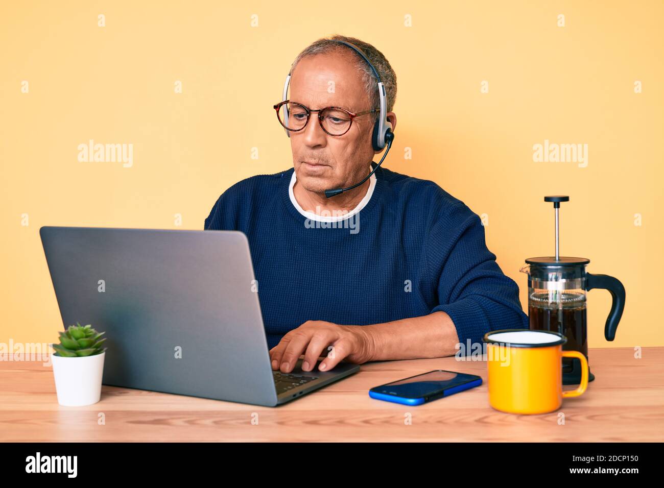 Senior handsome man with gray hair working at the office wearing ...