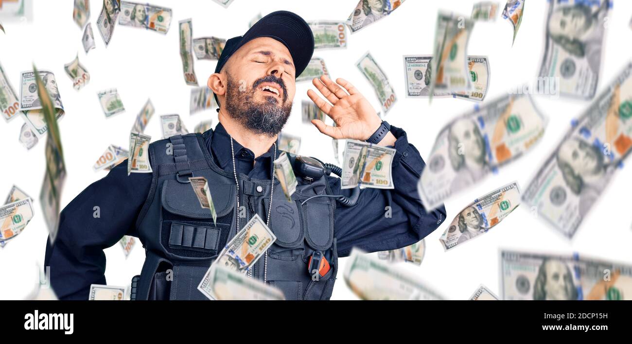 Young handsome man wearing police uniform stretching back, tired and ...