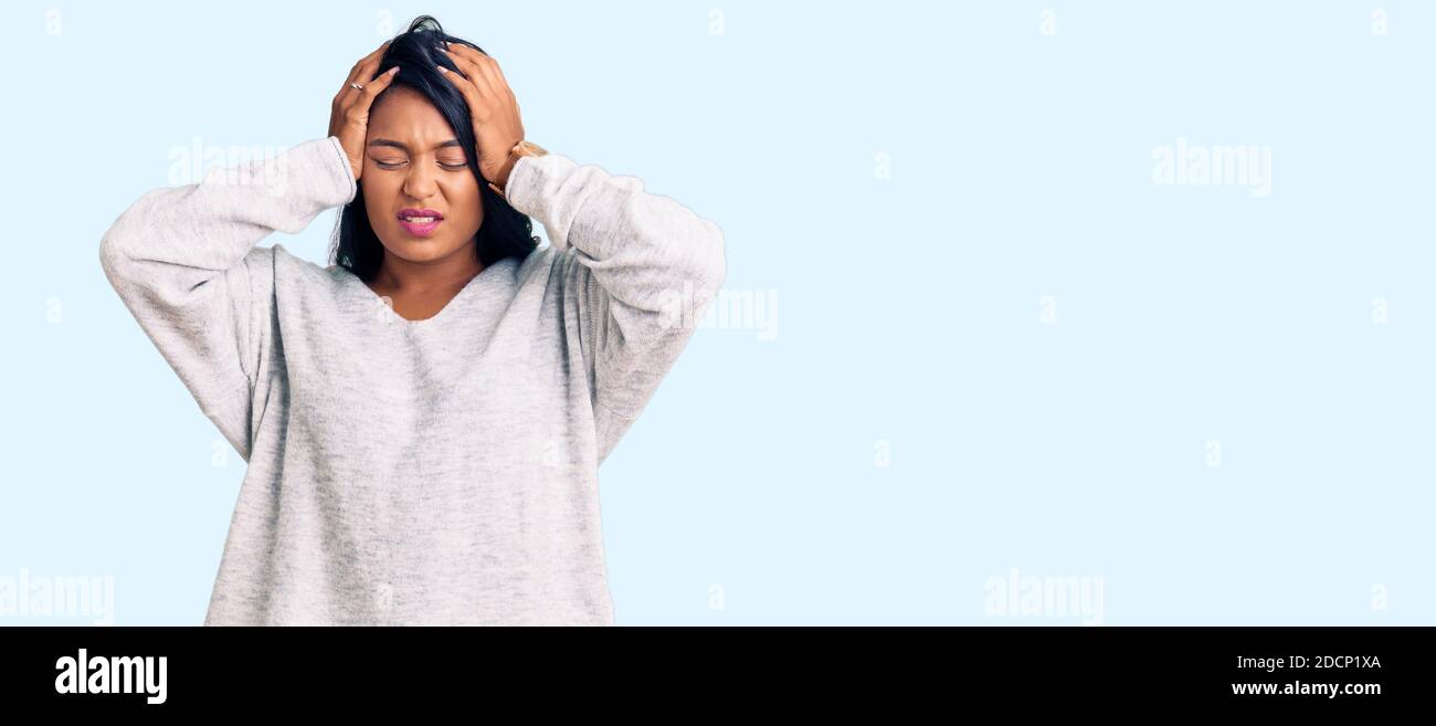 Hispanic woman with long hair wearing casual clothes suffering from ...