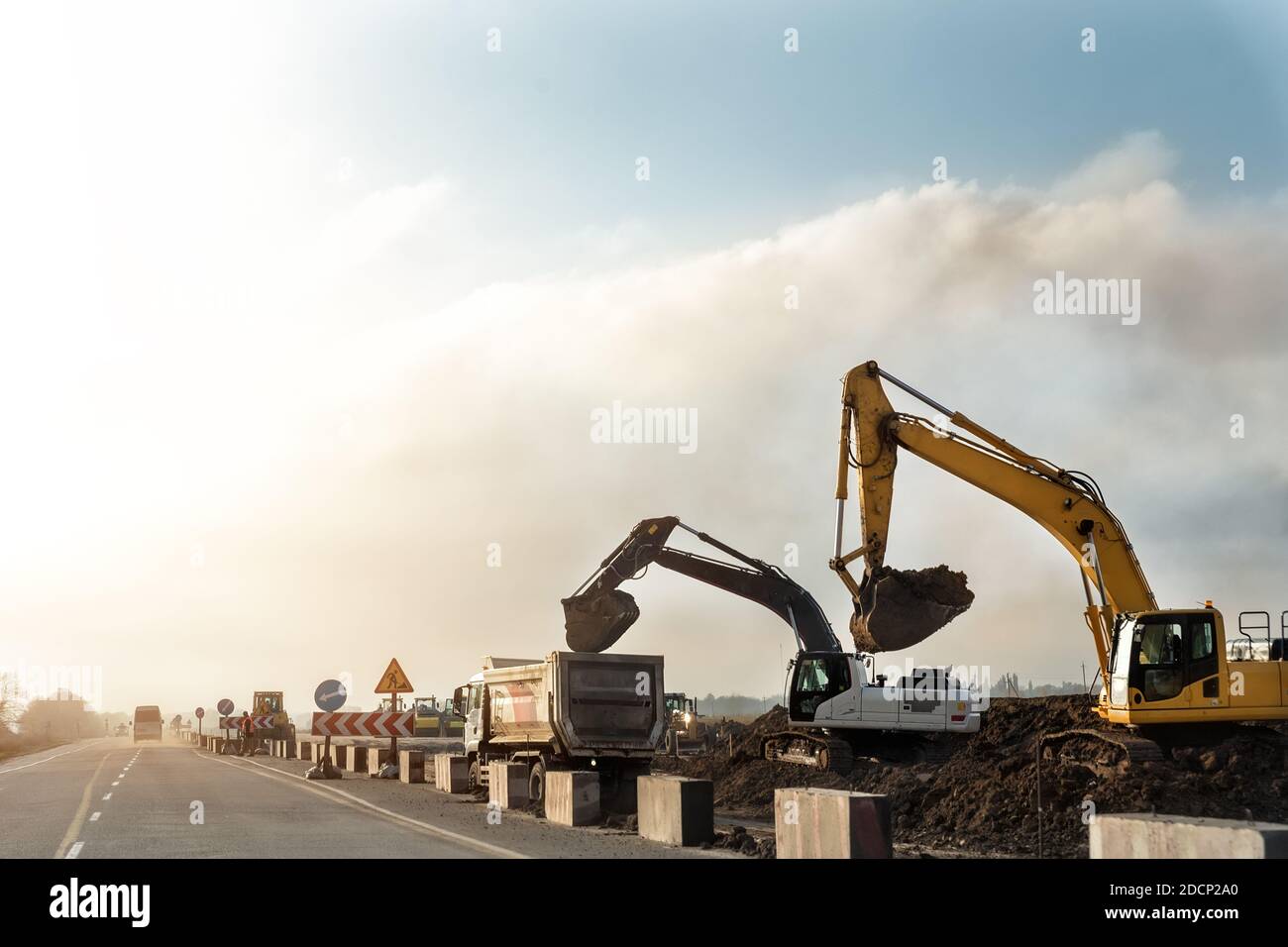 Many heavy heavy industrial road construction machinery on new highway ...