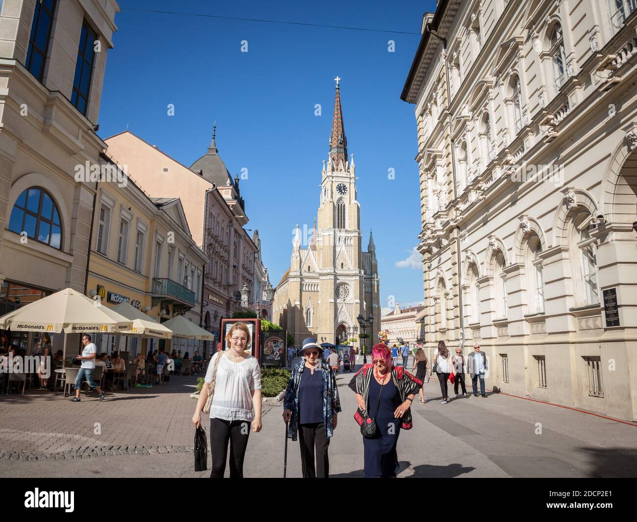 NOVI SAD, SERBIA - JUNE 11, 2011: Senior old women walking by The Name ...